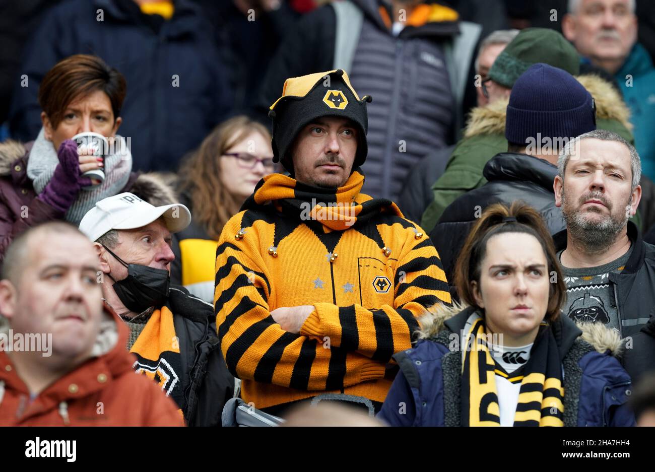 A Wolverhampton Wanderers fan wearing the club colours in the stands ...