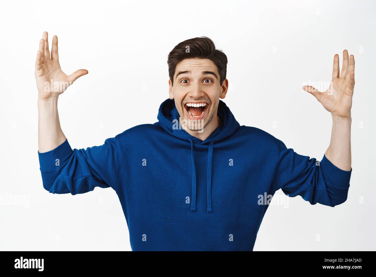 Image of happy man smiling, showing smth big and celebrating, winning ...