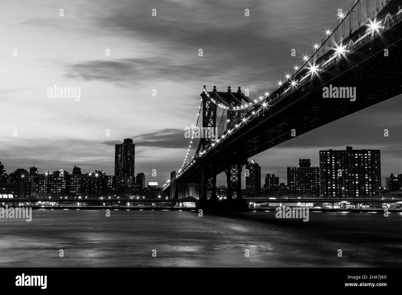 Grayscale of an illuminated bridge in a modern cit Stock Photo - Alamy
