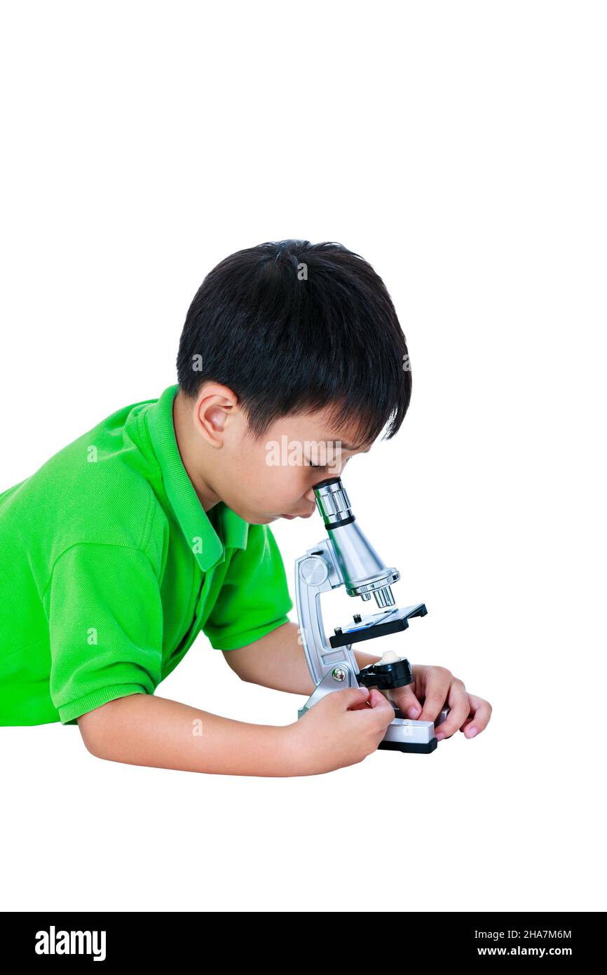 Asian child observed through a microscope biological preparations. Boy ...
