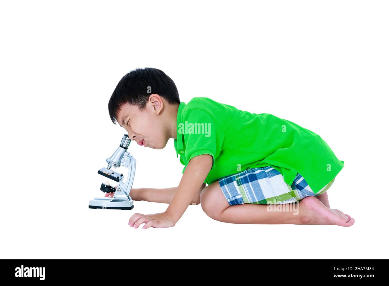 Child surprised. Full body of asian boy observed through a microscope ...