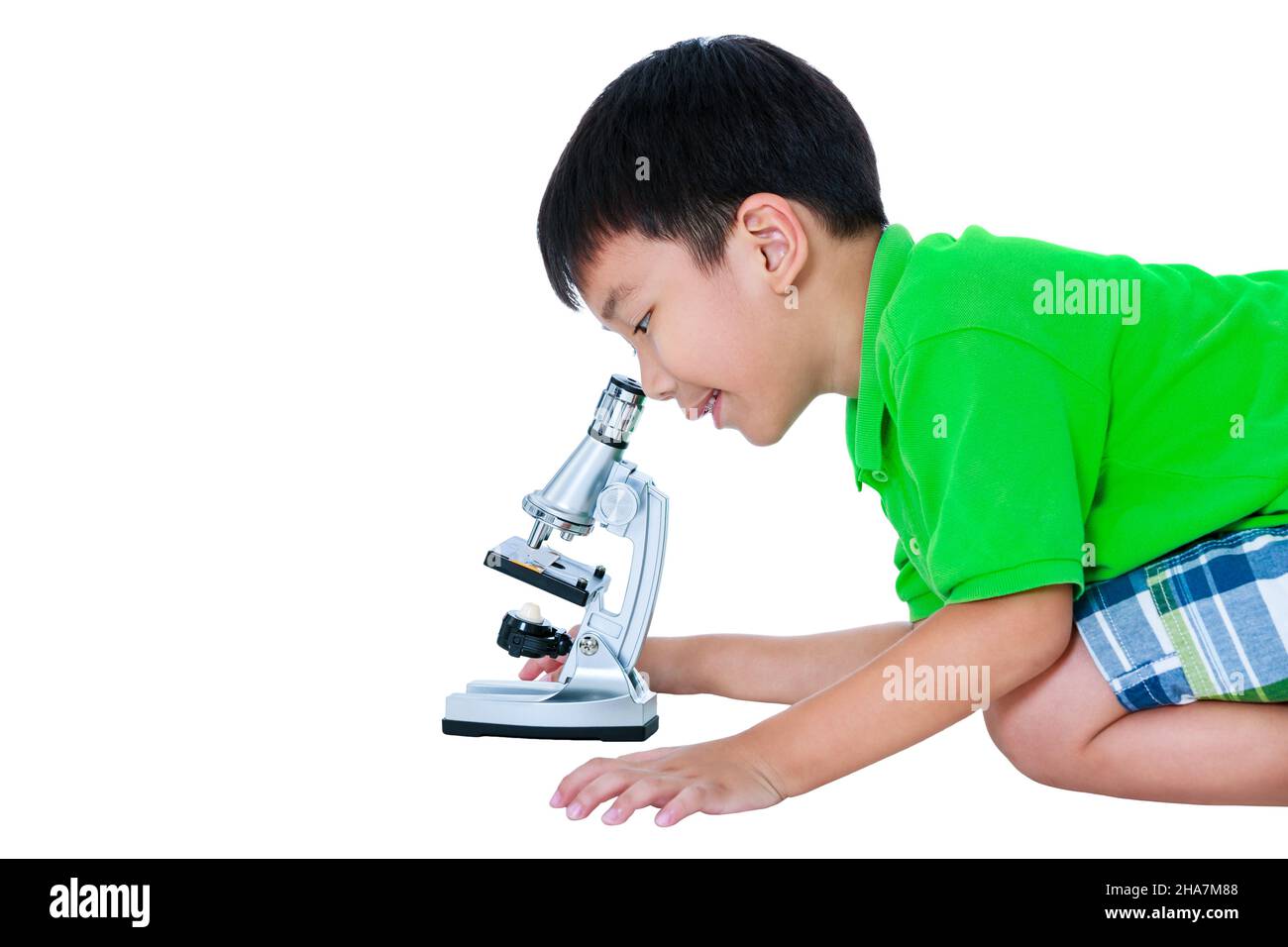 Asian child observed through a microscope biological preparations with ...
