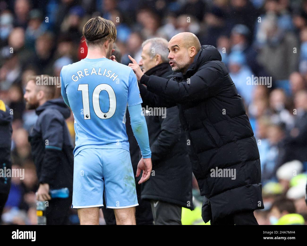 Manchester City manager Pep Guardiola (right) instructs Jack Grealish ...