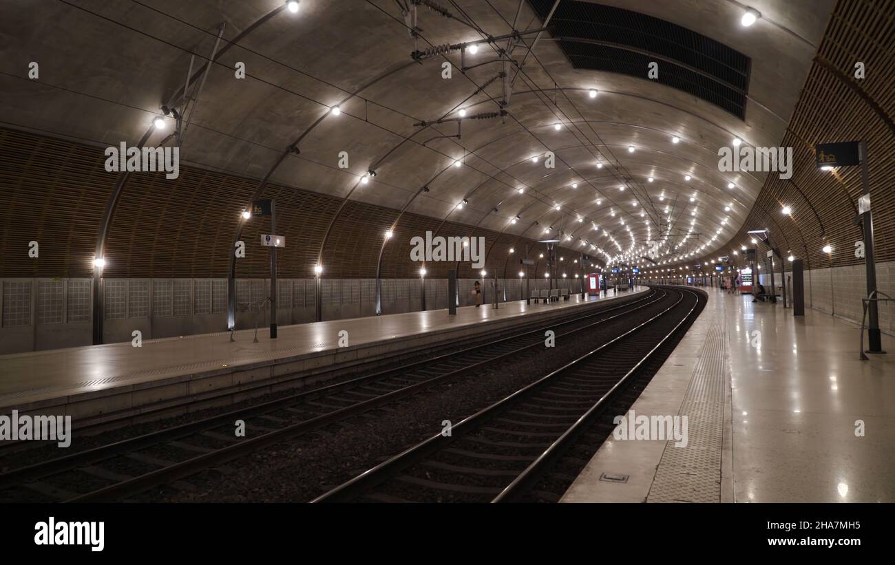 Underground subway tunnel with bright lighting. Action. Simple stone ...