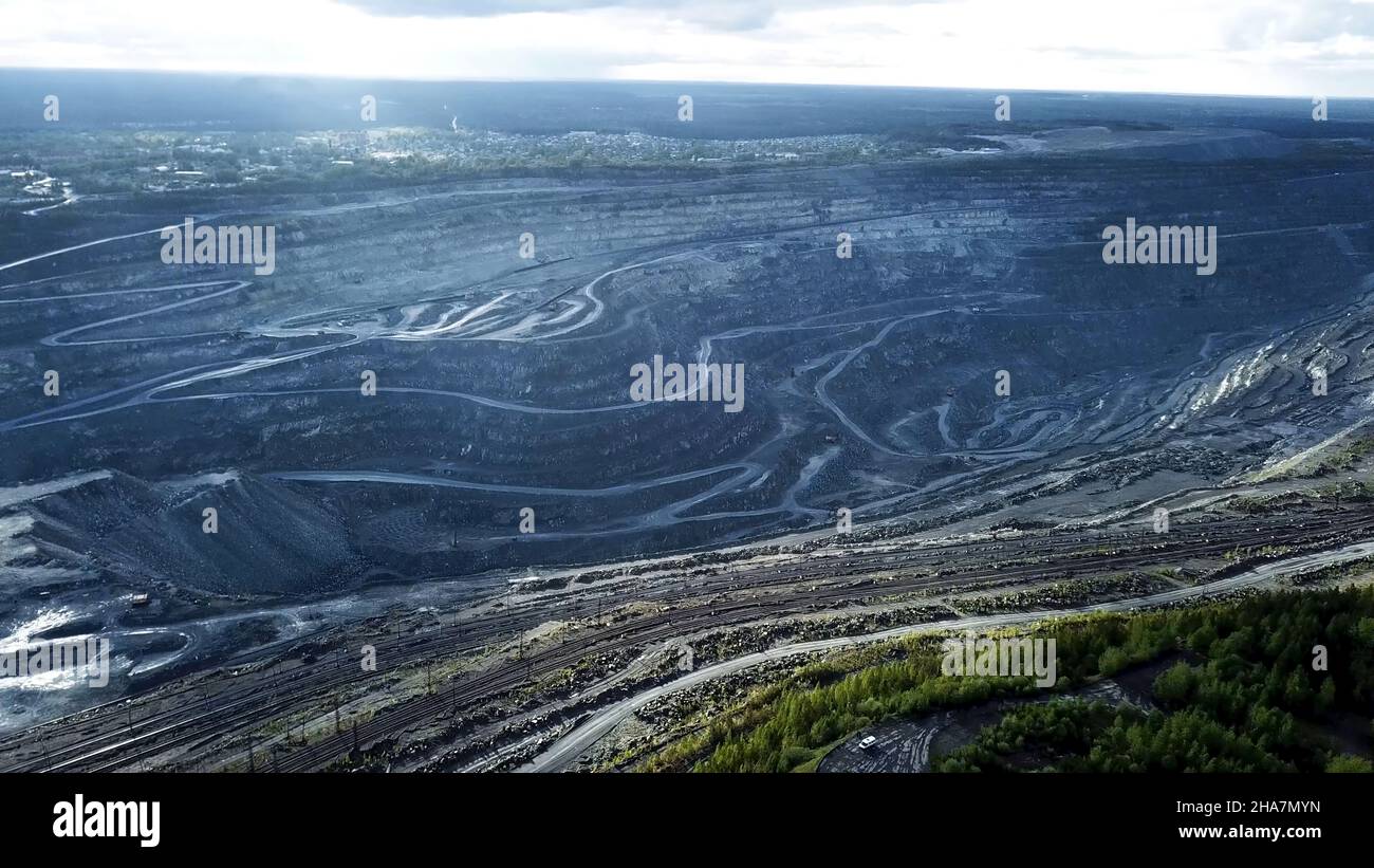 Coal mining at an open pit. Top view of the quarry. Dozers and trucks ...