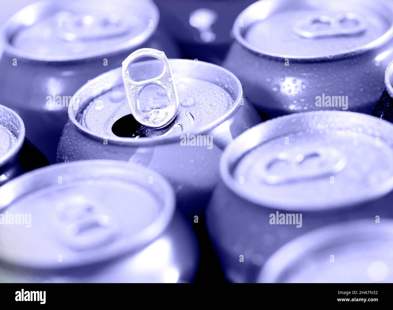 Cans of sweet drinks (or beer). Cooling frozen and with water drops ...