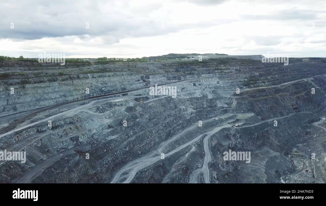 Coal mining at an open pit. Top view of the quarry. Dozers and trucks ...