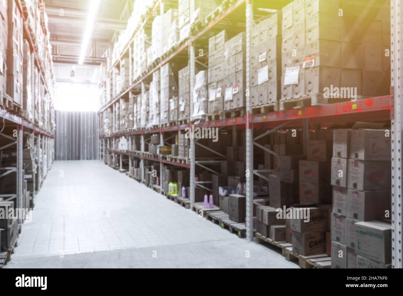 interior of a logistics center with boxes and large racks, blurred ...