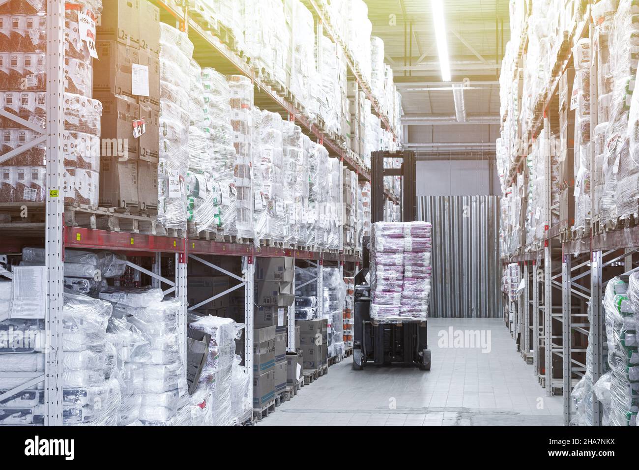 logistics transport center with racks and loader Stock Photo - Alamy
