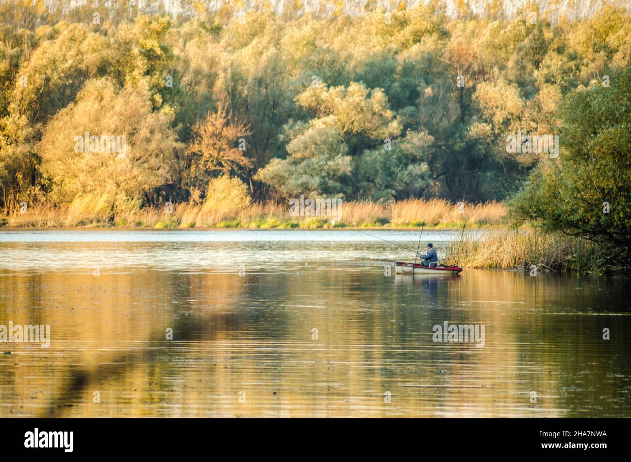 Begec, Serbia - October 30. 2021: Sport fisherman in a boat on an ...