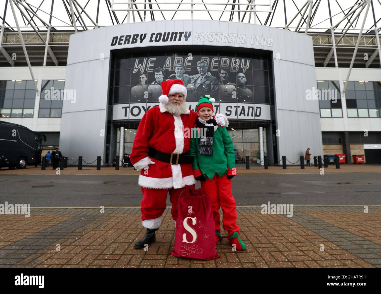 Fans dressed as Santa Claus and an elf outside the ground before the ...