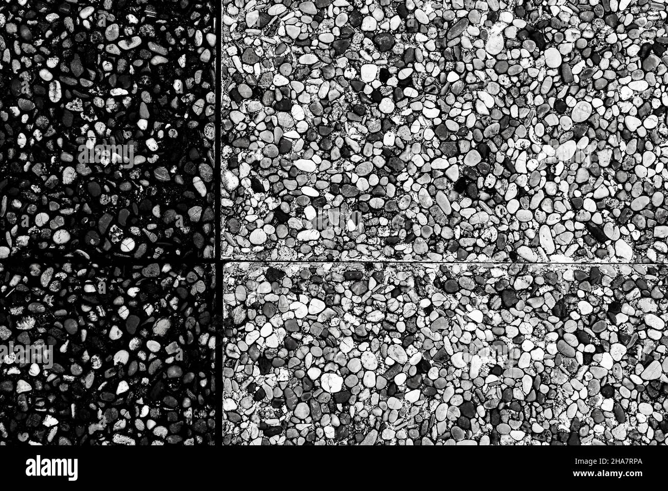 Black pebble stone in outdoor tiles. Textured surface. Close-up. Copy ...