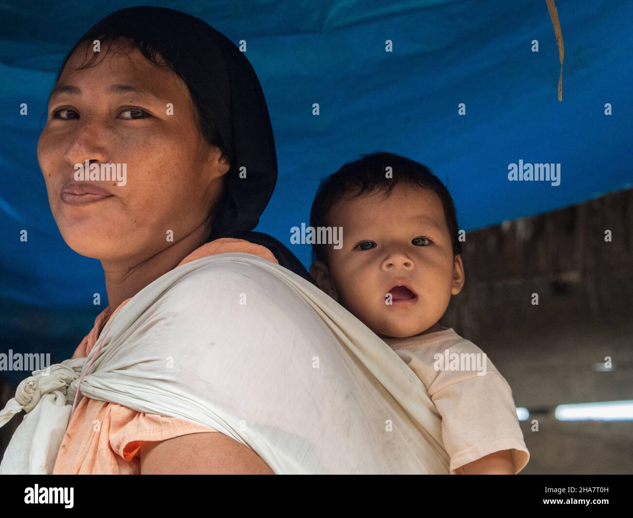 Amazonia, Peru - December 2017: A mother with a small child in a sling ...