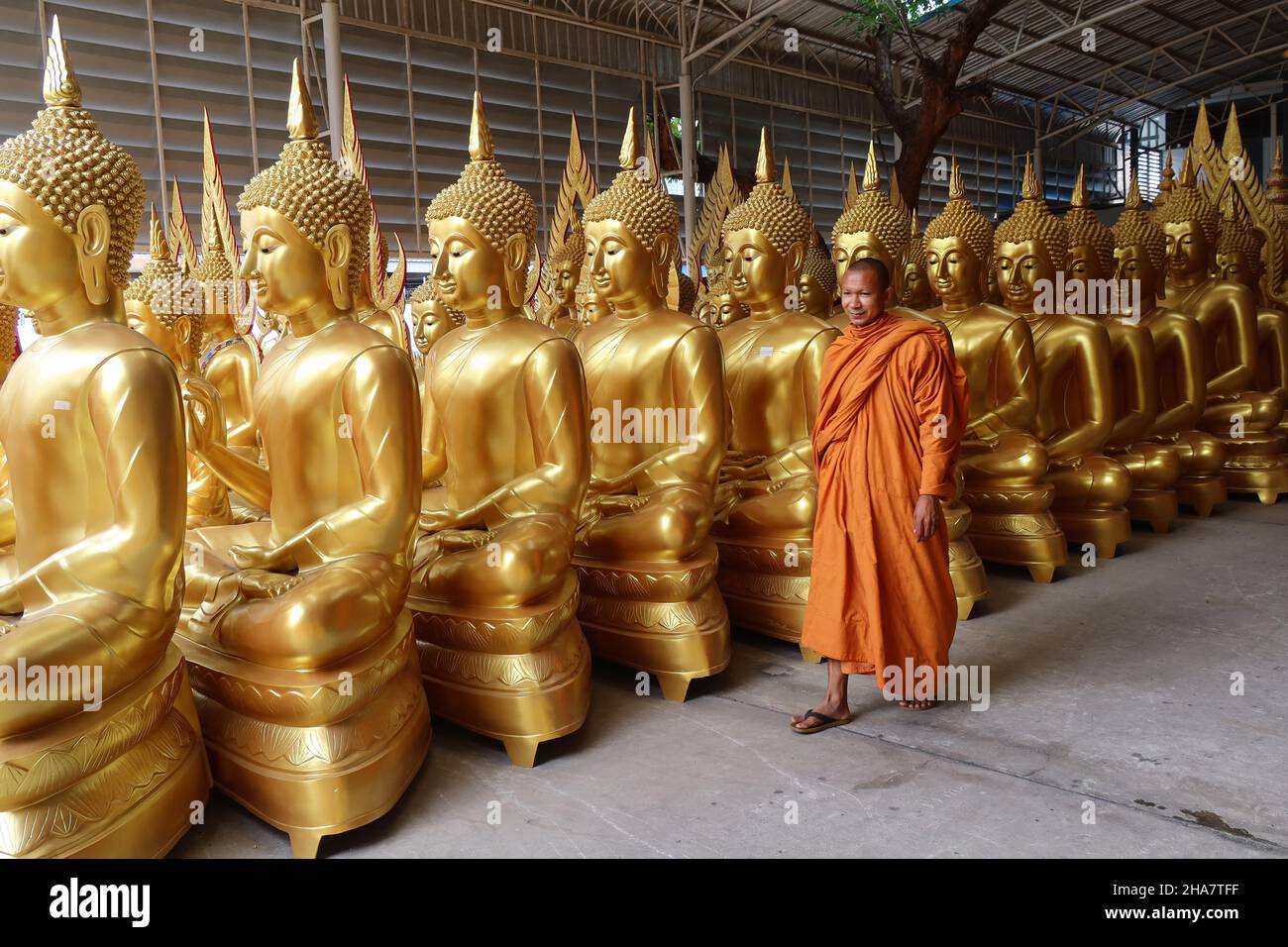 Monk with buddhist statues hi-res stock photography and images - Alamy