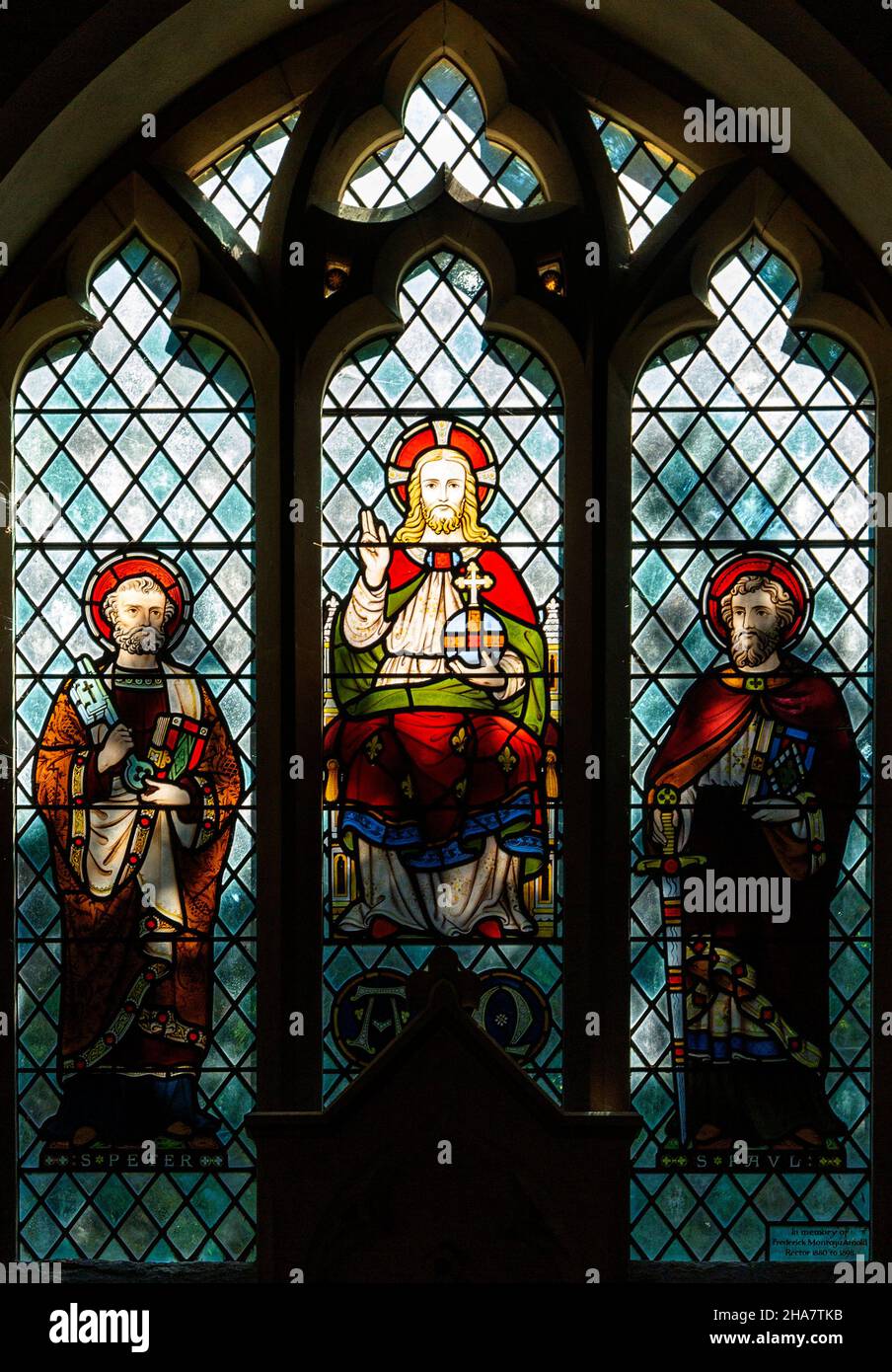 Stained glass window depicting Jesus Christ flanked by Saints Peter and ...