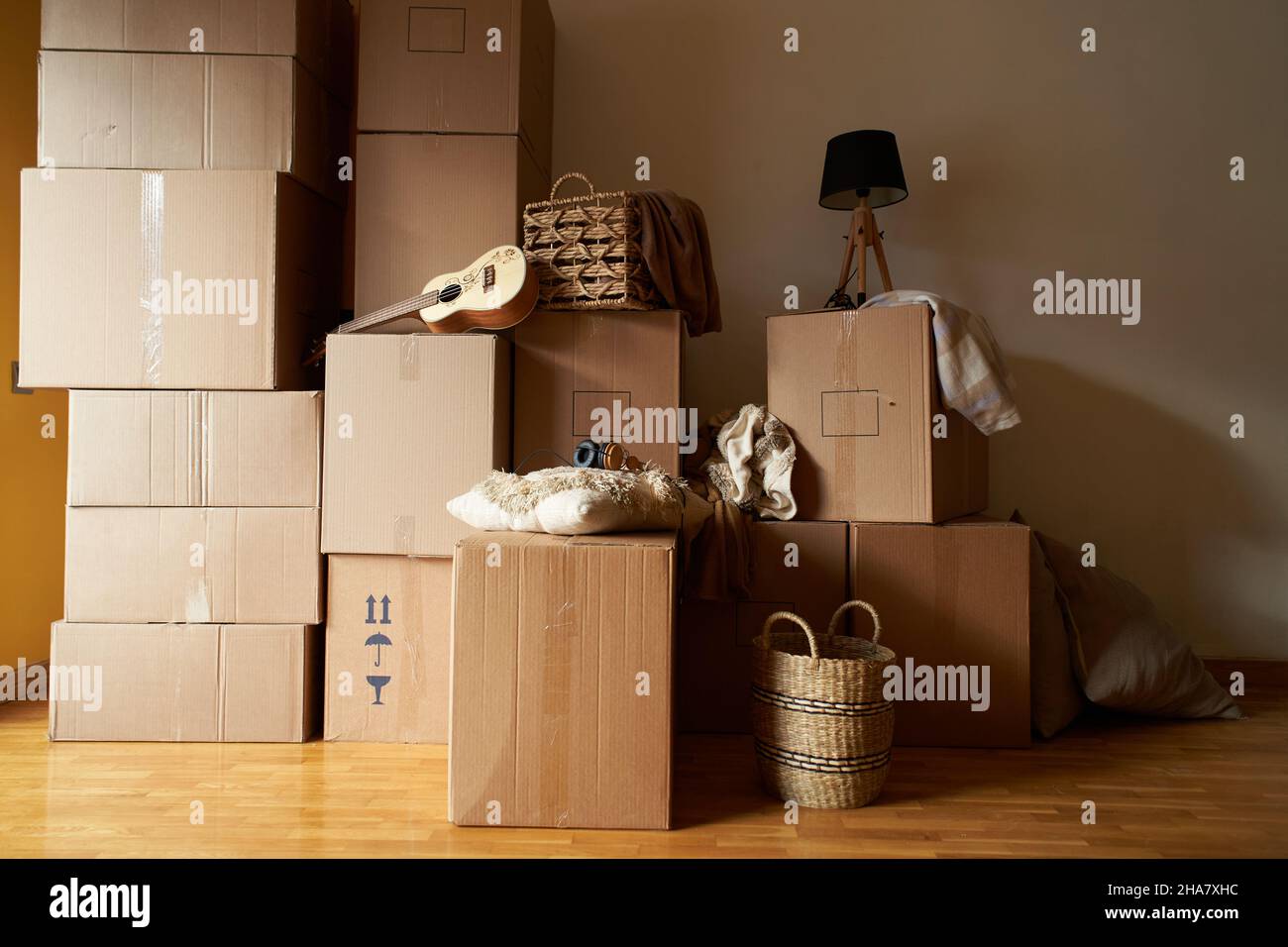Background image of cardboard boxes stacked in empty room with personal ...