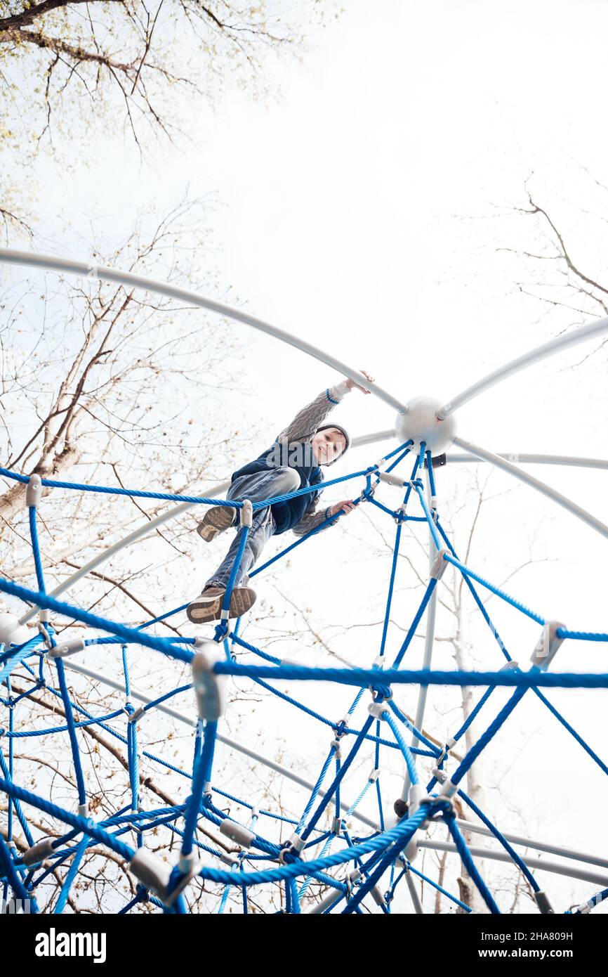 beautiful little boy playing in a rope maze Stock Photo - Alamy