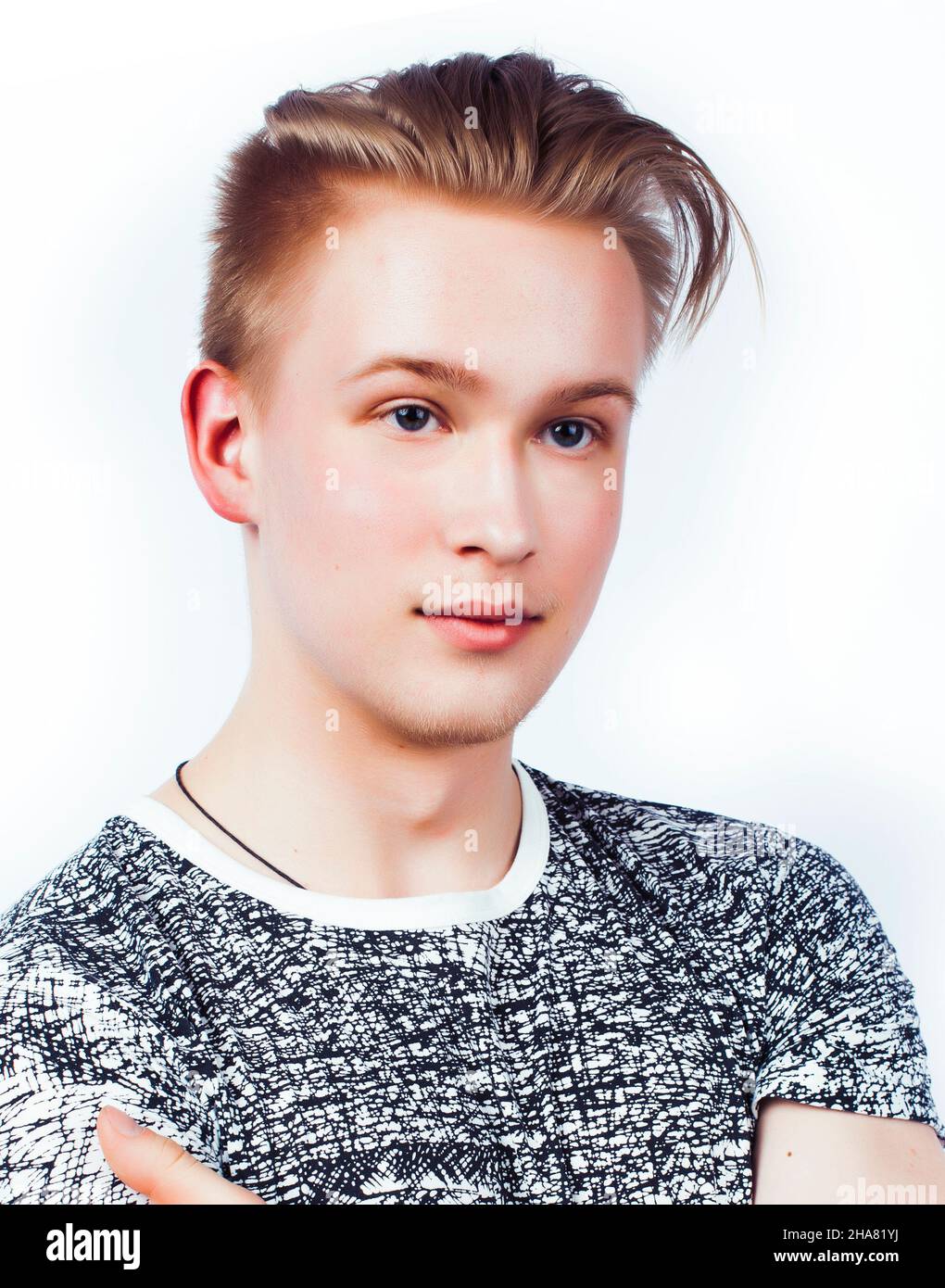 young handsome teenage hipster guy posing emotional, happy smiling against white background ...
