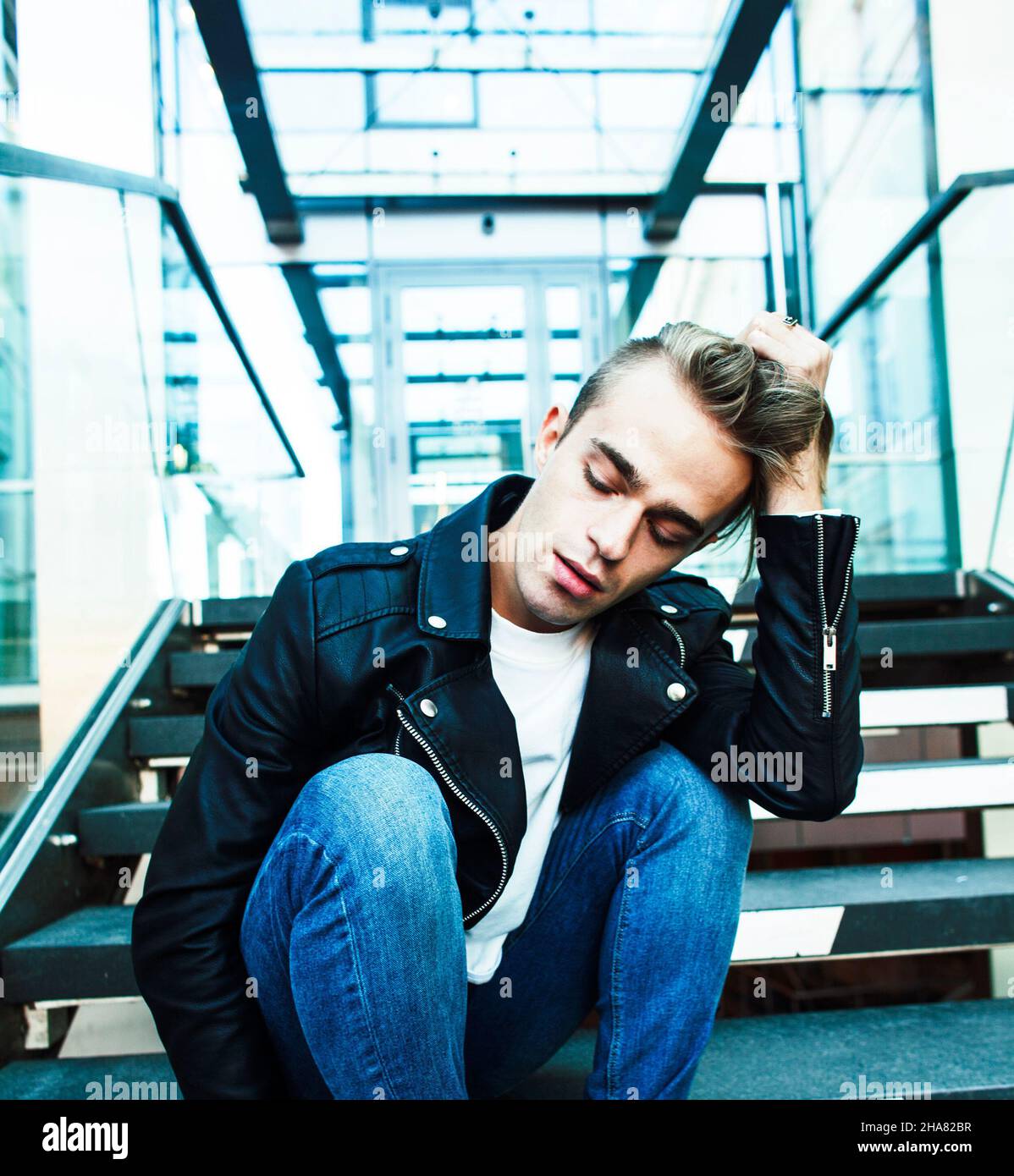 young modern hipster guy at new building university blond fashion ...