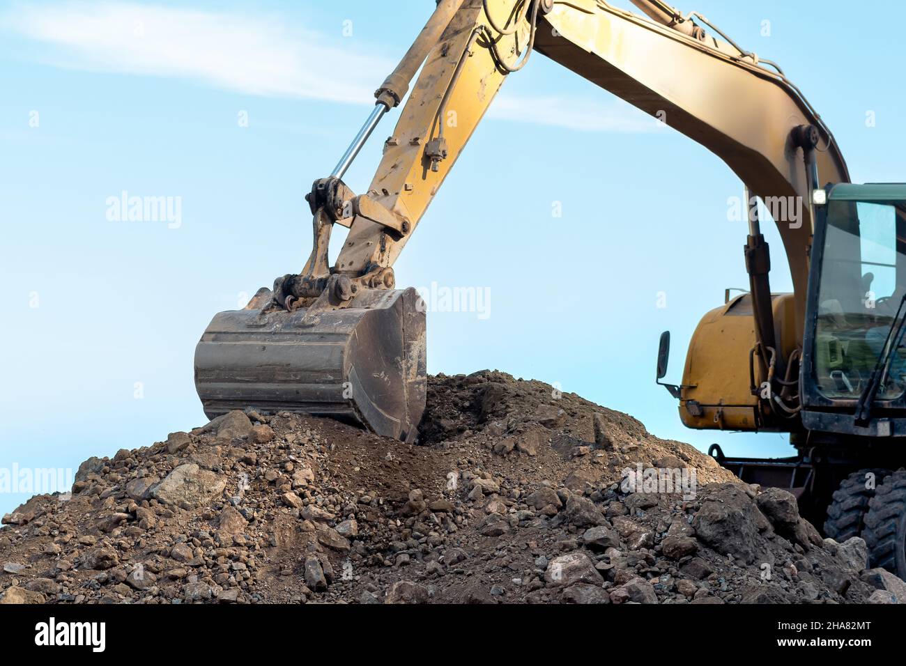 wheeled excavator carries out road construction work close-up Stock ...