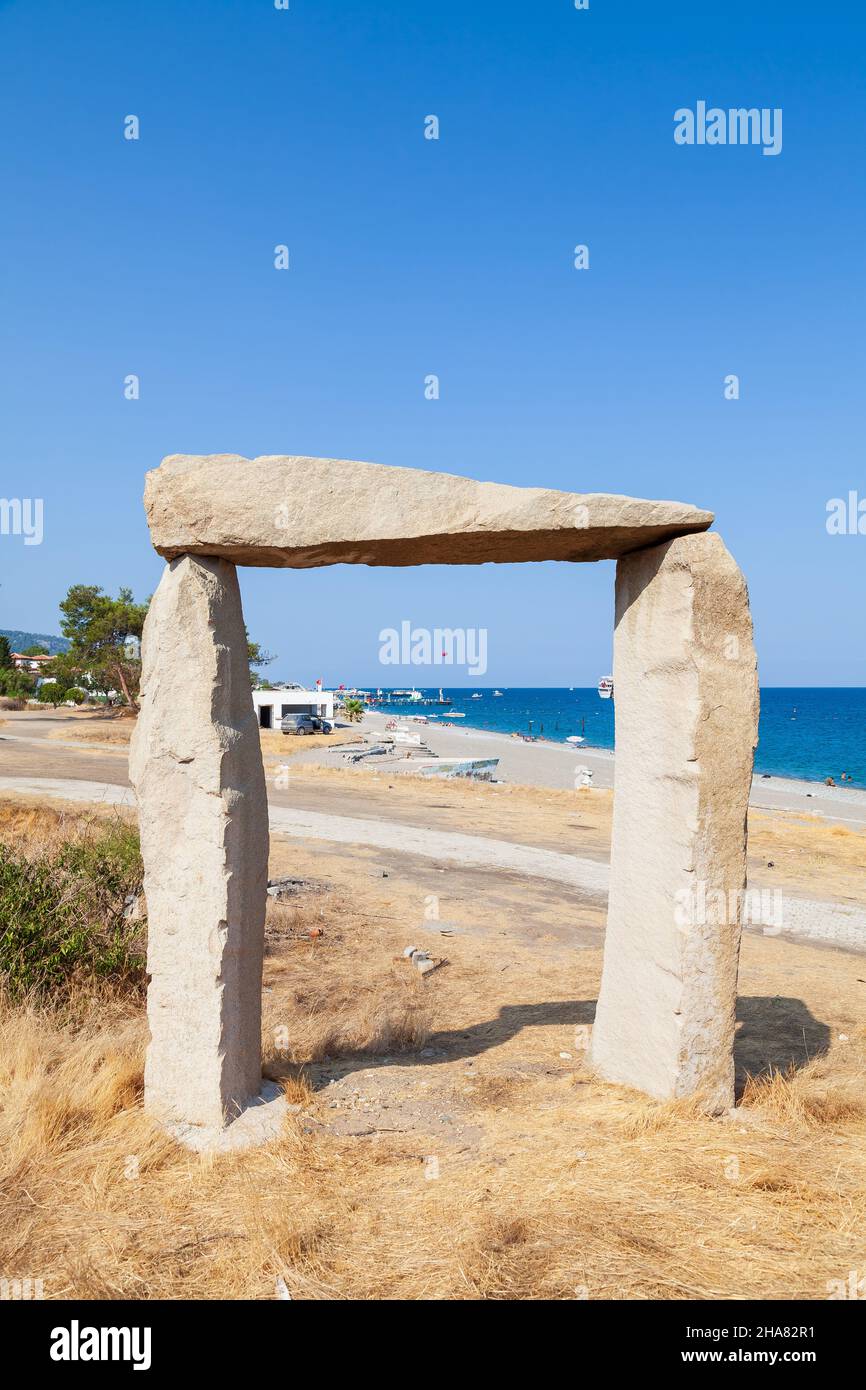 An old three-stone arch on a beach in turkey as a local landmark with a ...