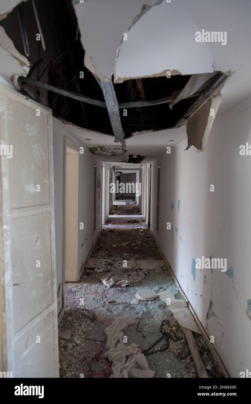 Scary empty dark corridor in an abandoned building. Shabby walls. The ...