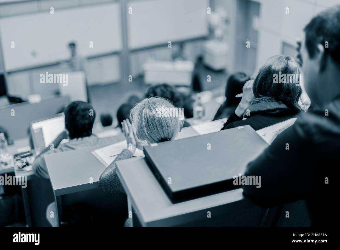 Speaker giving presentation in lecture hall at university. Participants ...
