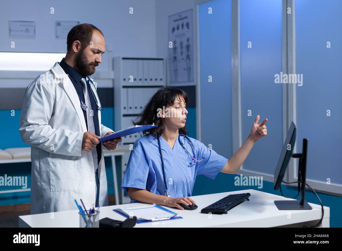 Medical team of specialists looking at computer for healthcare ...