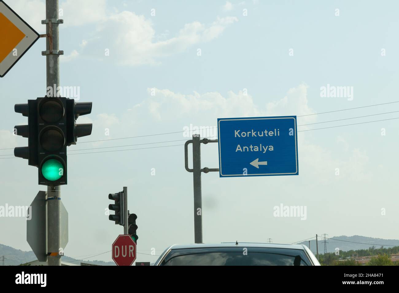 Kemer, Turkey - 08. 28. 2021: Traffic Light on green, with blue sign ...