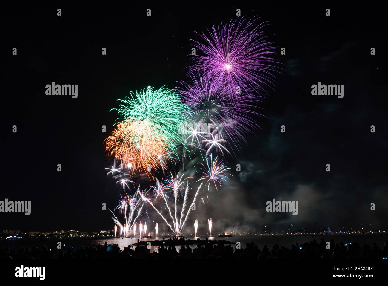 Scenic fireworks glowing in the night for the 14th of July celebrations ...