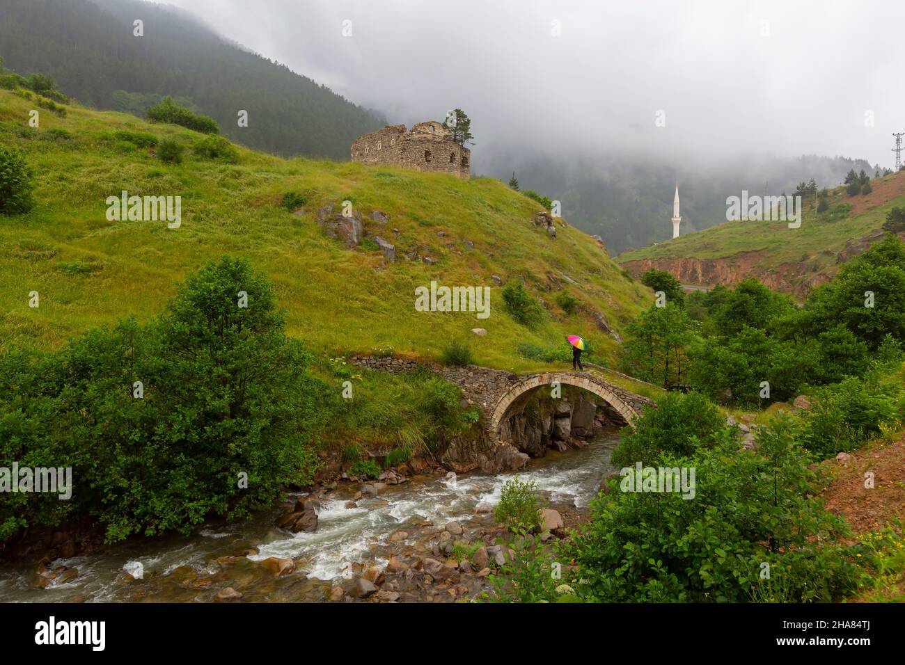 View of a arch bridge with minaret in the old greek church. Alucra ...