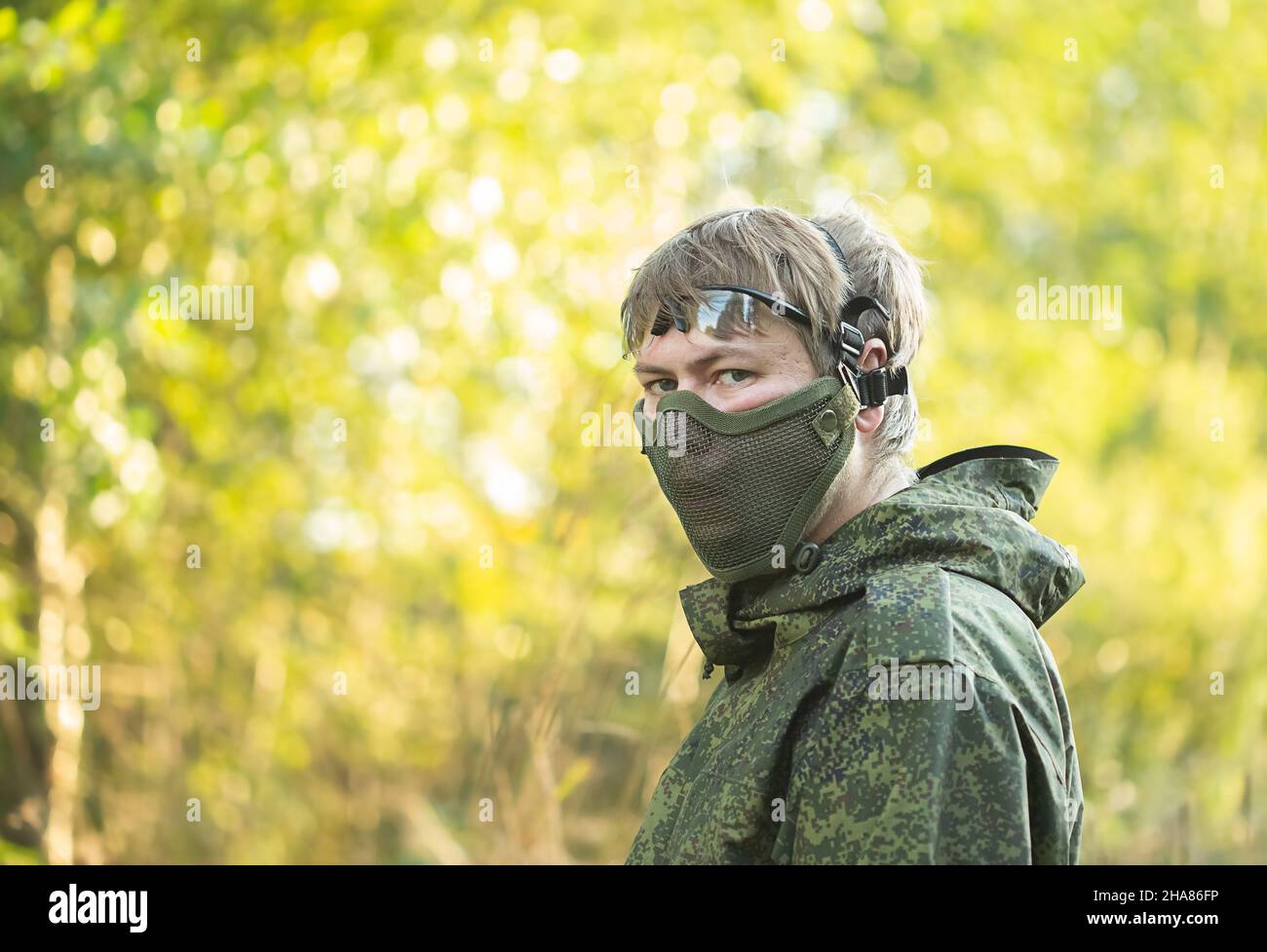 Portrait of Fully equipped military men in security mask with automatic ...