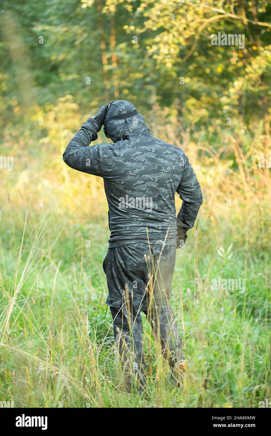 Fully equipped military men with automatic weapons getting ready to ...