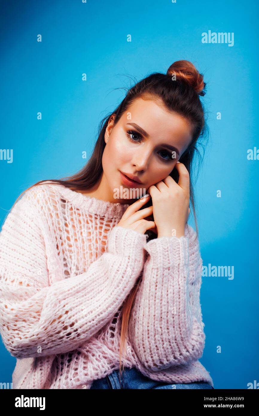 young pretty modern hipster girl posing emotional happy on blue background, lifestyle people ...