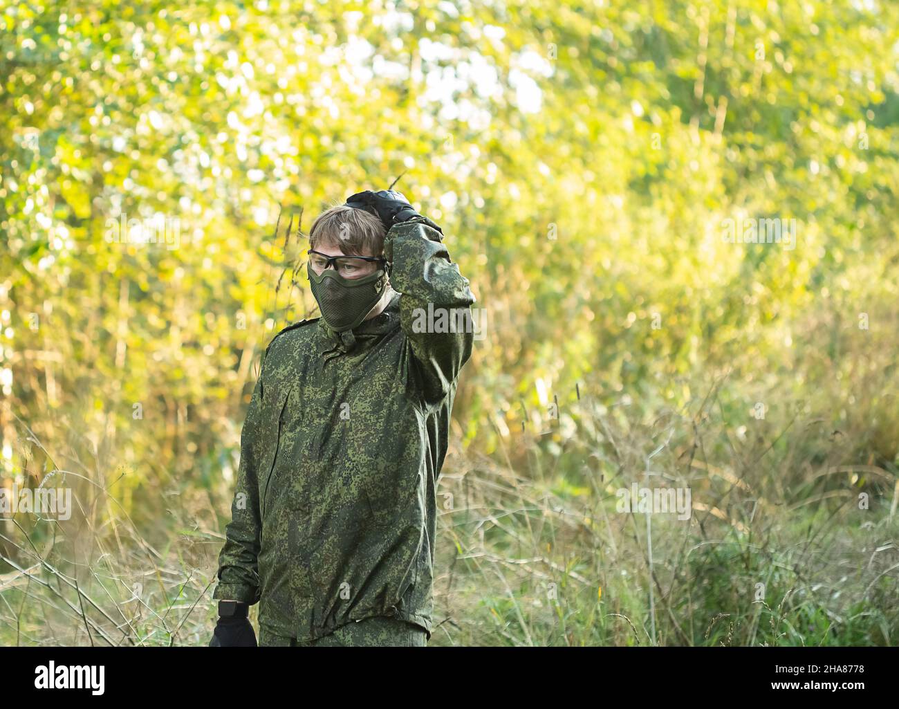 Portrait of Fully equipped military men in security mask with automatic ...