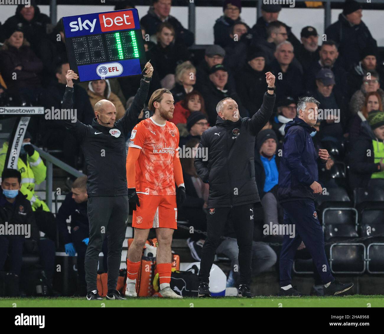 Josh Bowler #11 of Blackpool prepares to come on for Sonny Carey #16 of ...