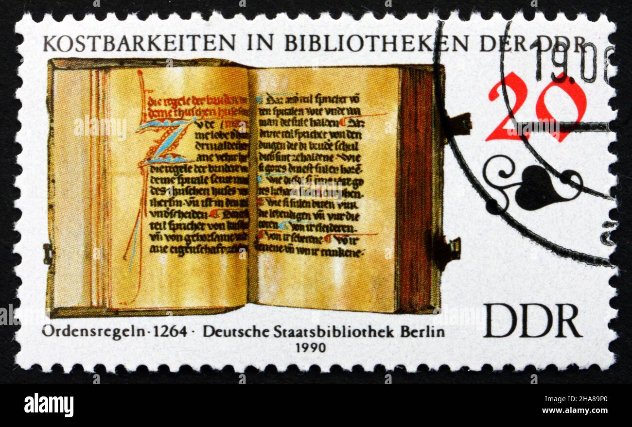 GDR - CIRCA 1990: a stamp printed in GDR shows Rules of an Order, Book ...