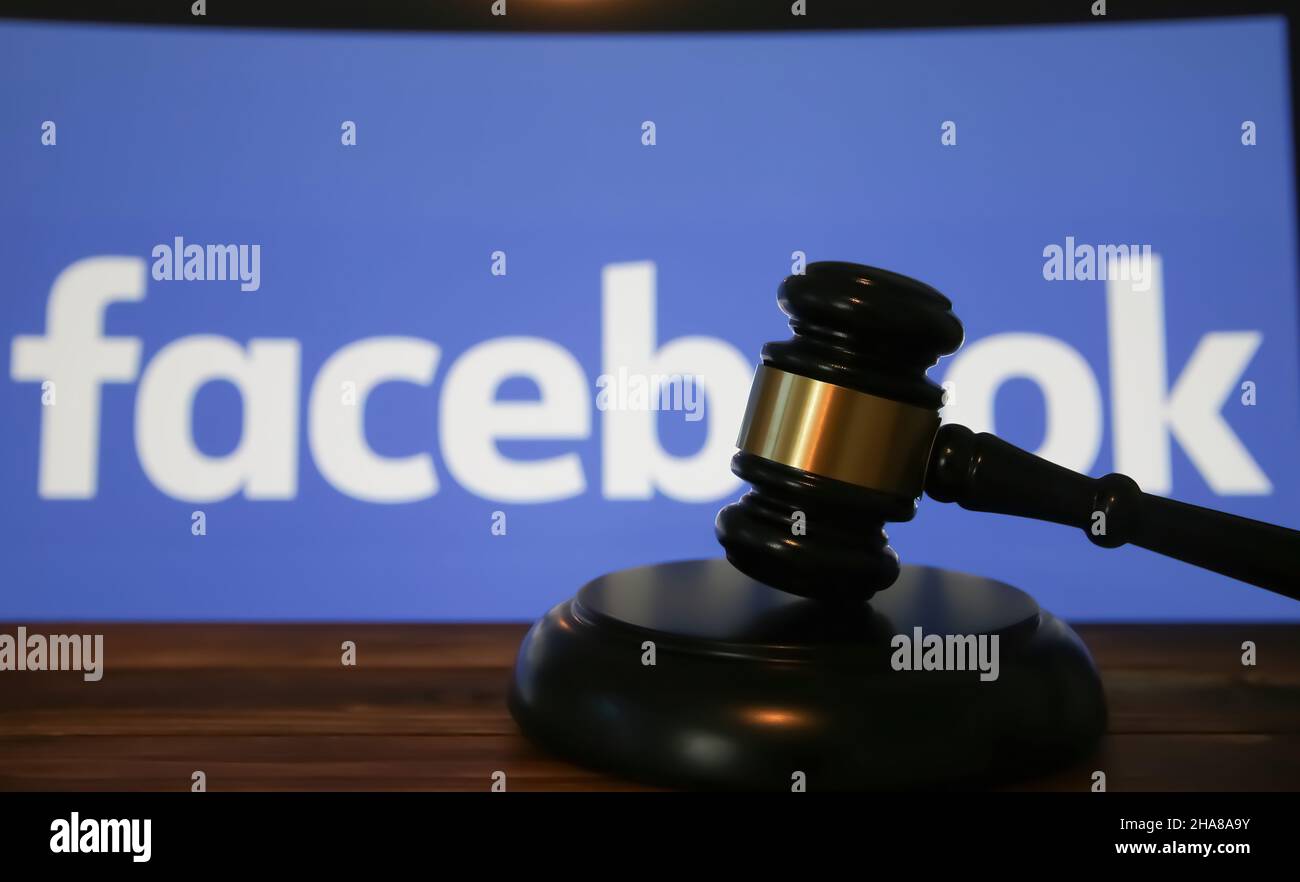 Closeup of isolated judge wood gavel with blurred facebook logo ...