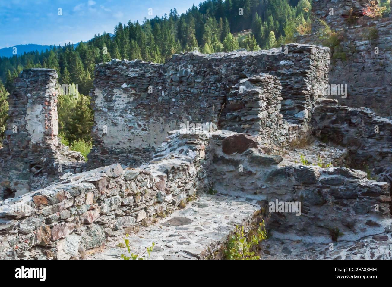 Detail of a ruined castle, with a panoramic view of the mountainous ...