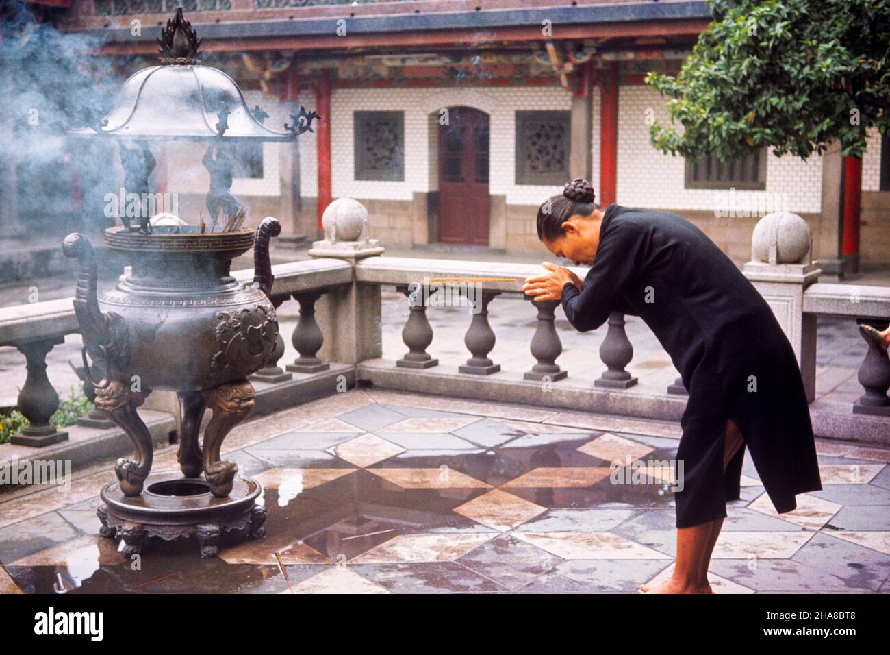 1970s ASIAN WOMAN BOWING BEFORE INCENSE BURNING VAT LUNGSHAN TEMPLE ...