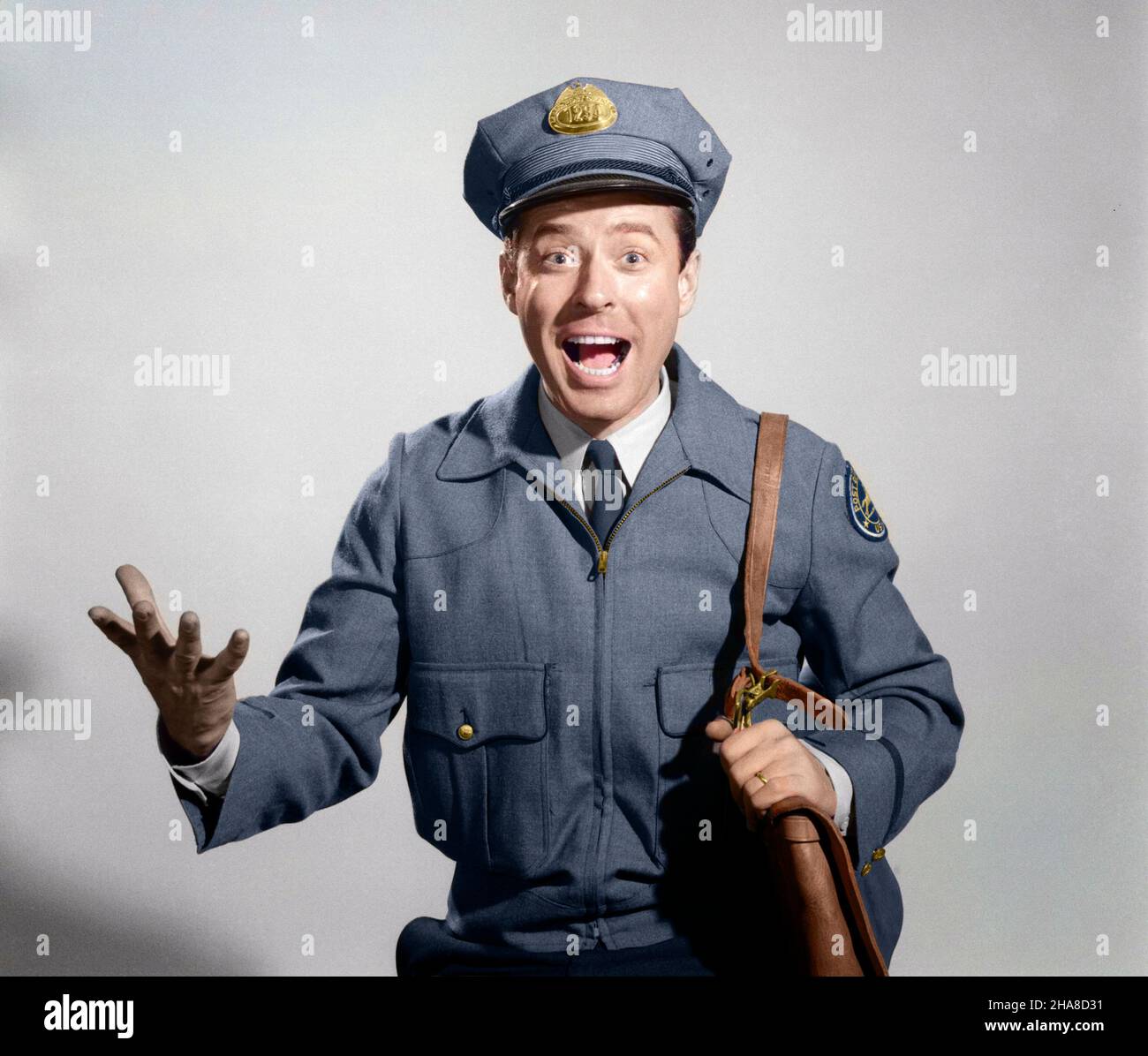 1960s HAPPY JOYFUL MAN MAILMAN POSTMAN IN UNIFORM LOOKING AT CAMERA 1960s HAPPY JOYFUL MAN MAILMAN POSTMAN IN UNIFORM LOOKING AT CAMERA