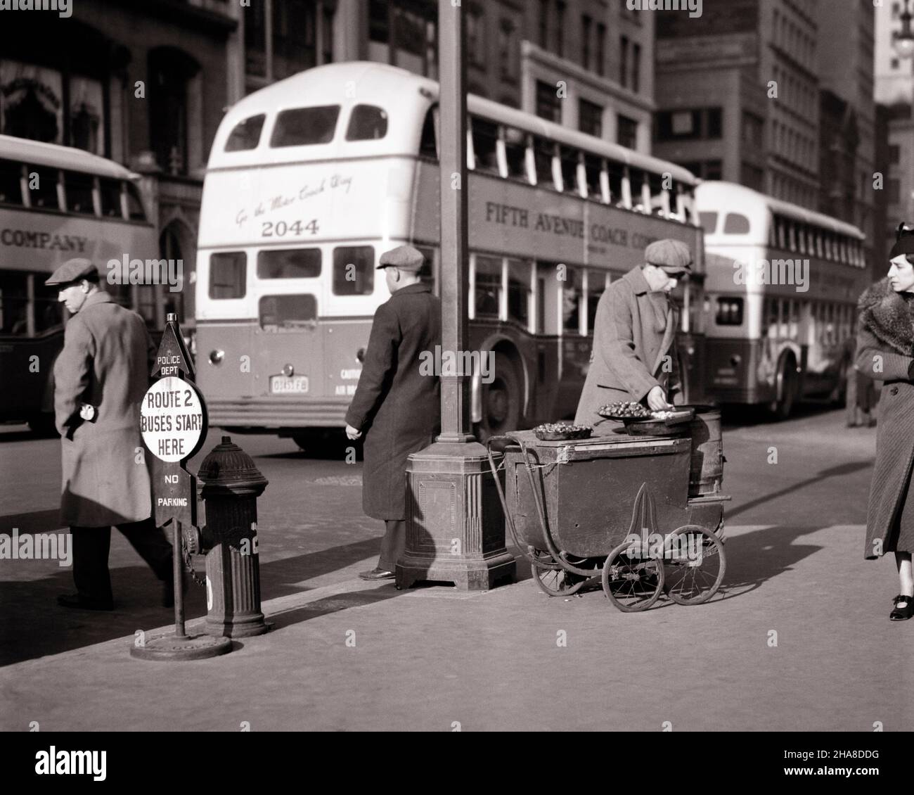 1930s THREE DOUBLE DECKER BUSES PASSING BY ROASTED CHESTNUT VENDOR ON ...