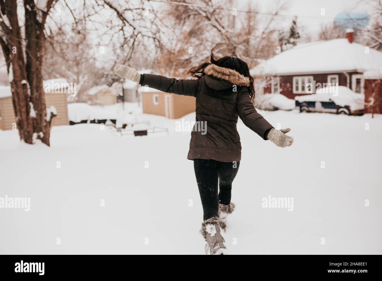Female runs through fresh snow after a snow storm Stock Photo - Alamy