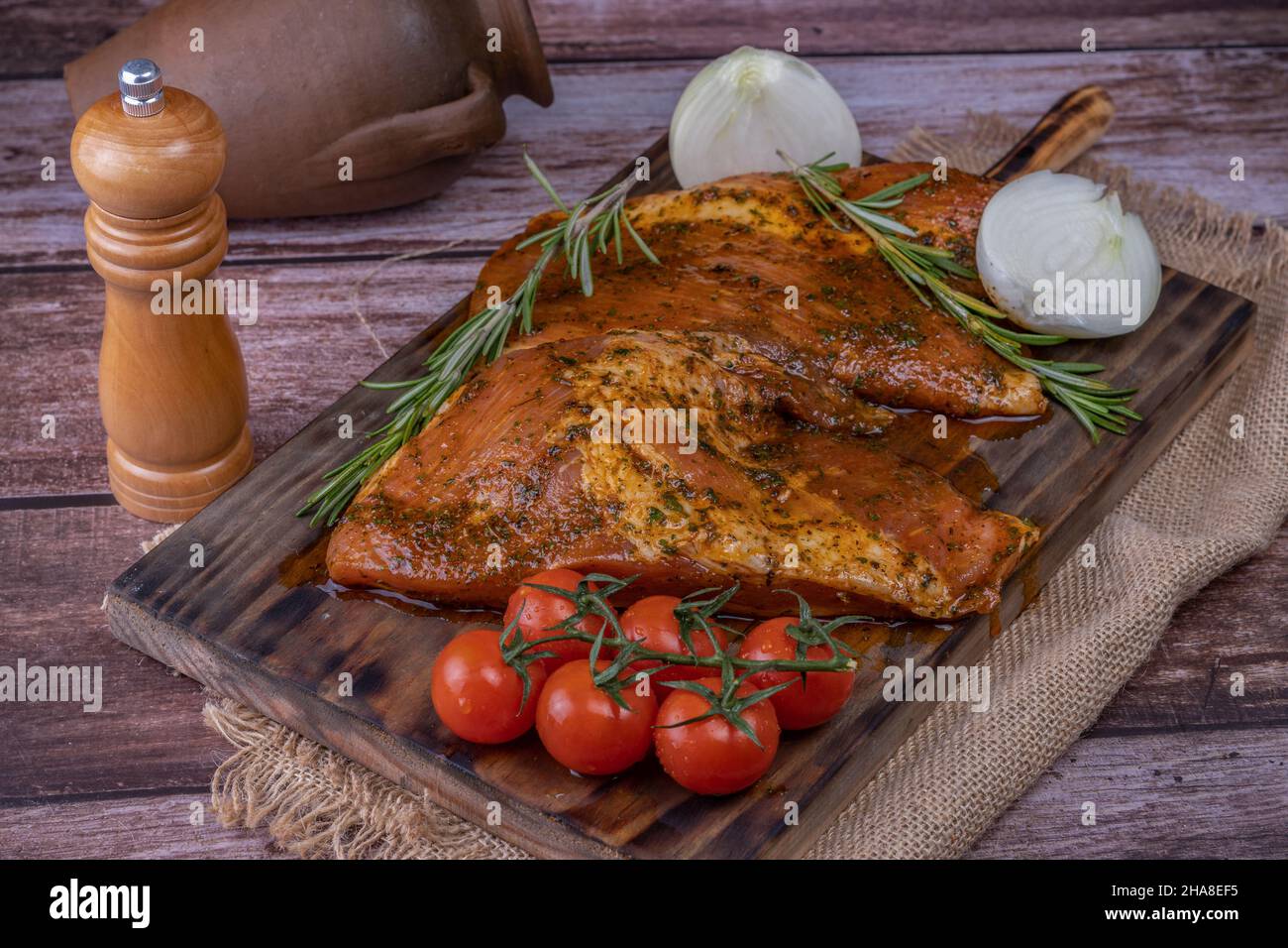 Raw slice of Iberian pork secret with roasted cherry tomato and fresh ...