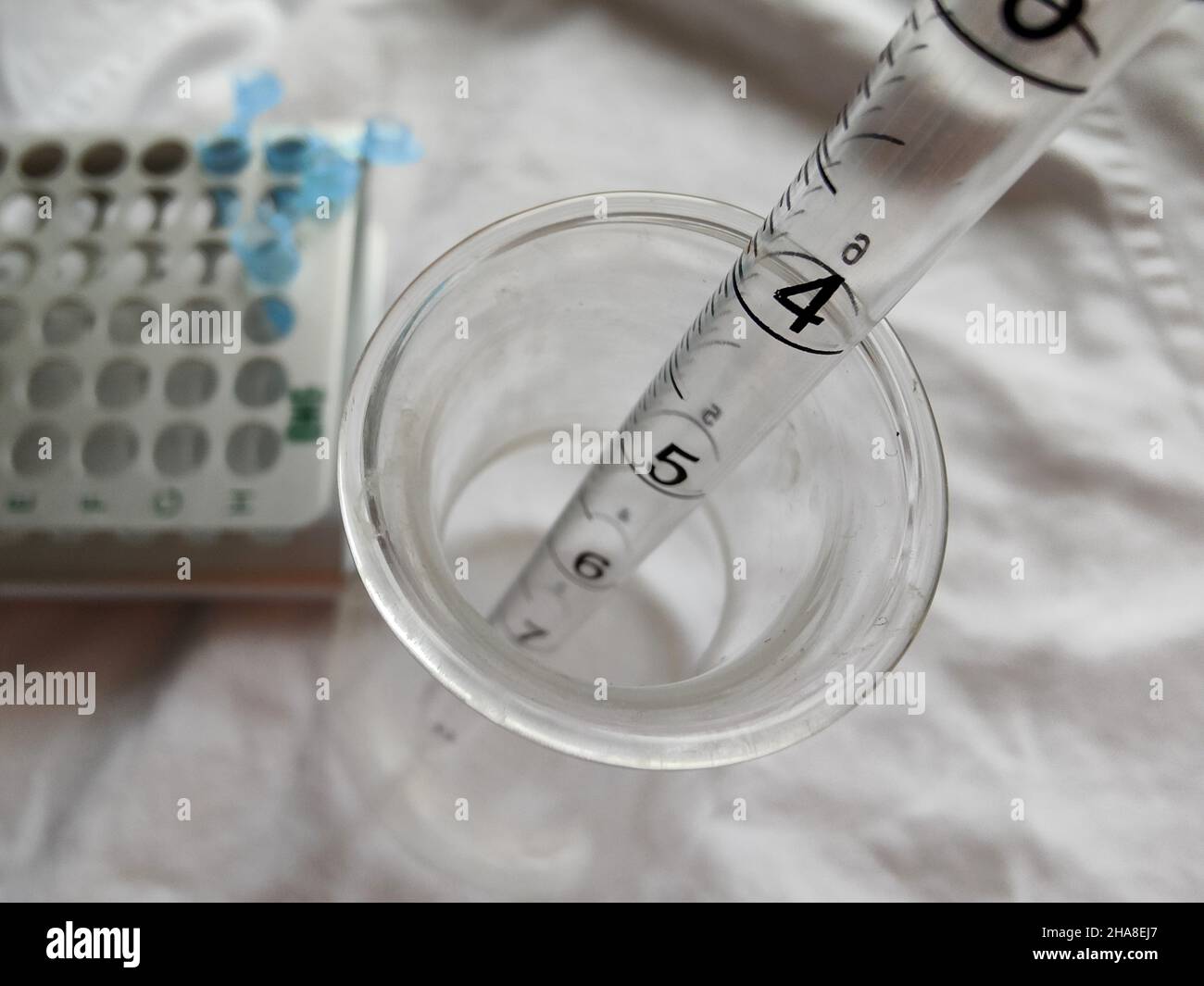 Laboratory pipette and glass flask Stock Photo - Alamy