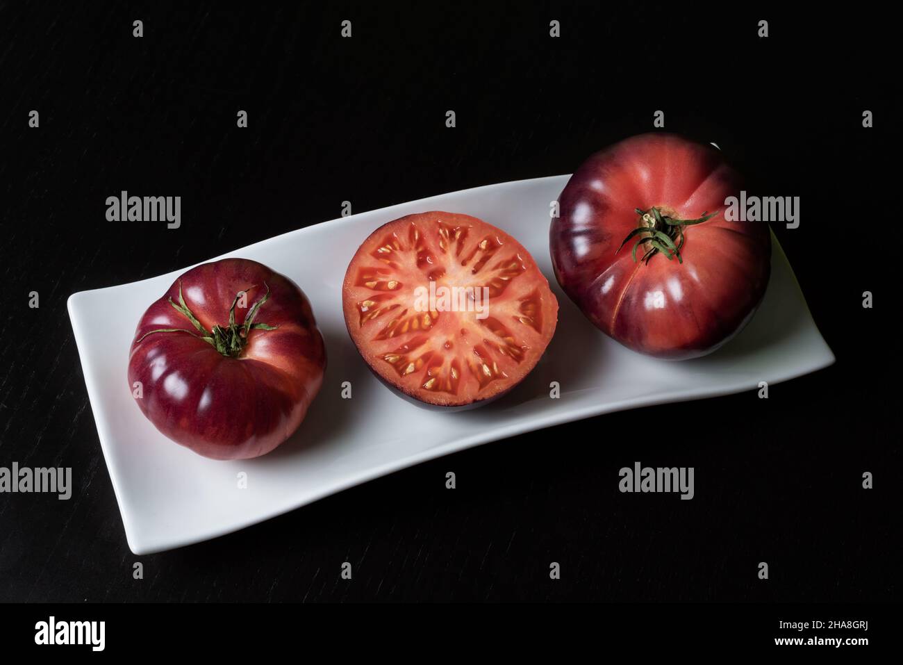 Tomatoes of the new variety Mar Azul, on a black background Stock Photo ...