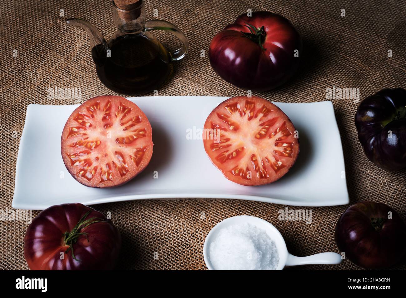 Tomato of the Mar Azul variety, split in half and presented on a plate ...