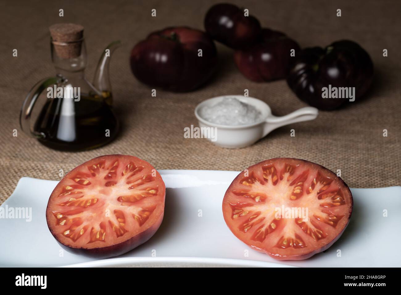 Tomato of the Mar Azul variety, split in half and presented on a plate ...