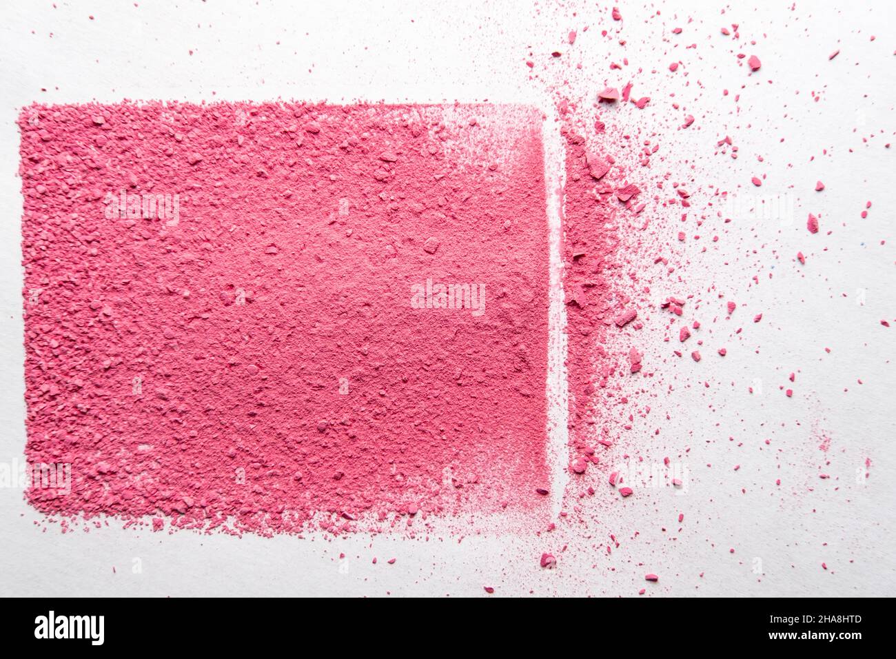 Bright red frame made of colorful powder on a white background. Copy ...
