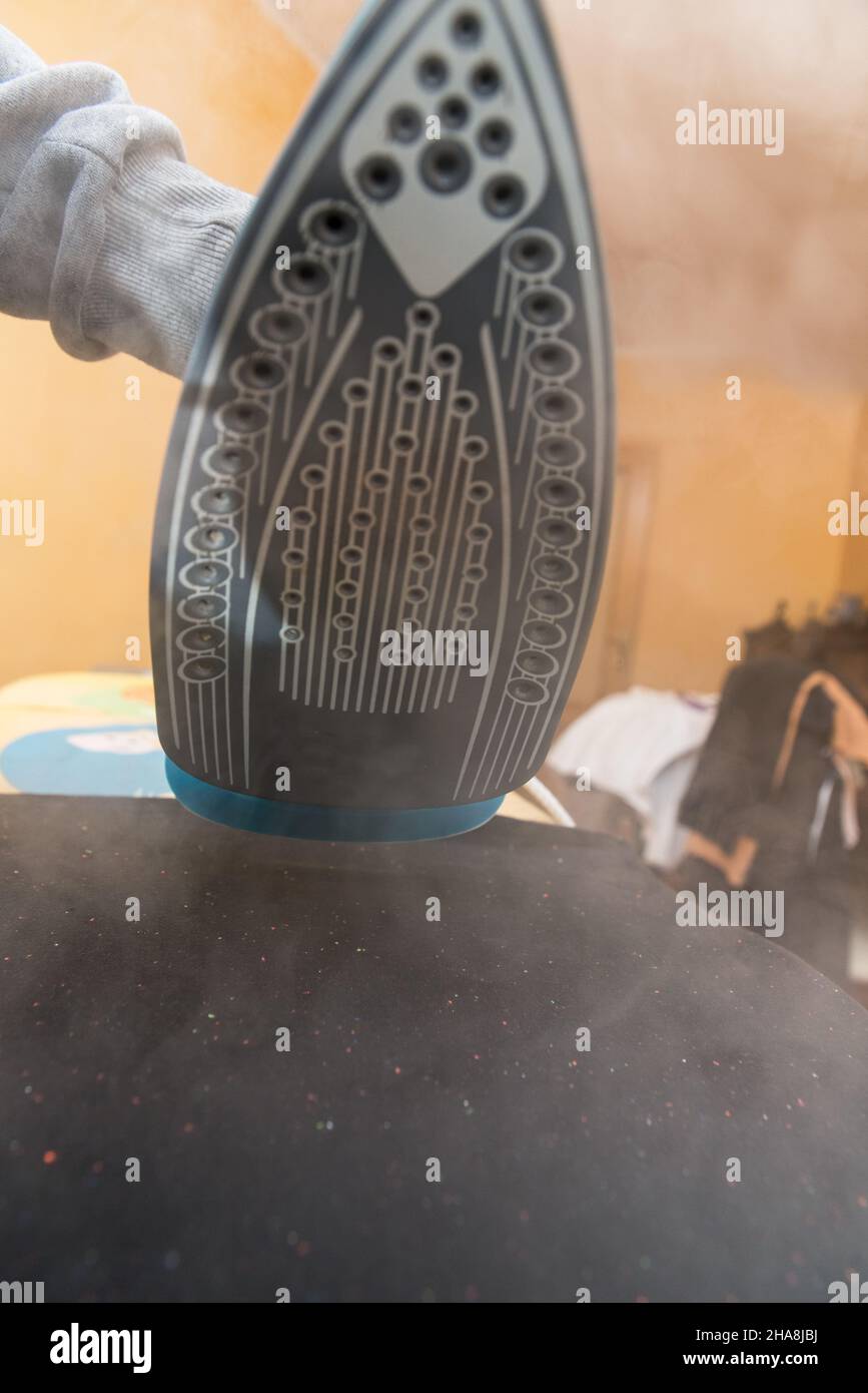 Iron releasing steam on black hi-res stock photography and images - Alamy